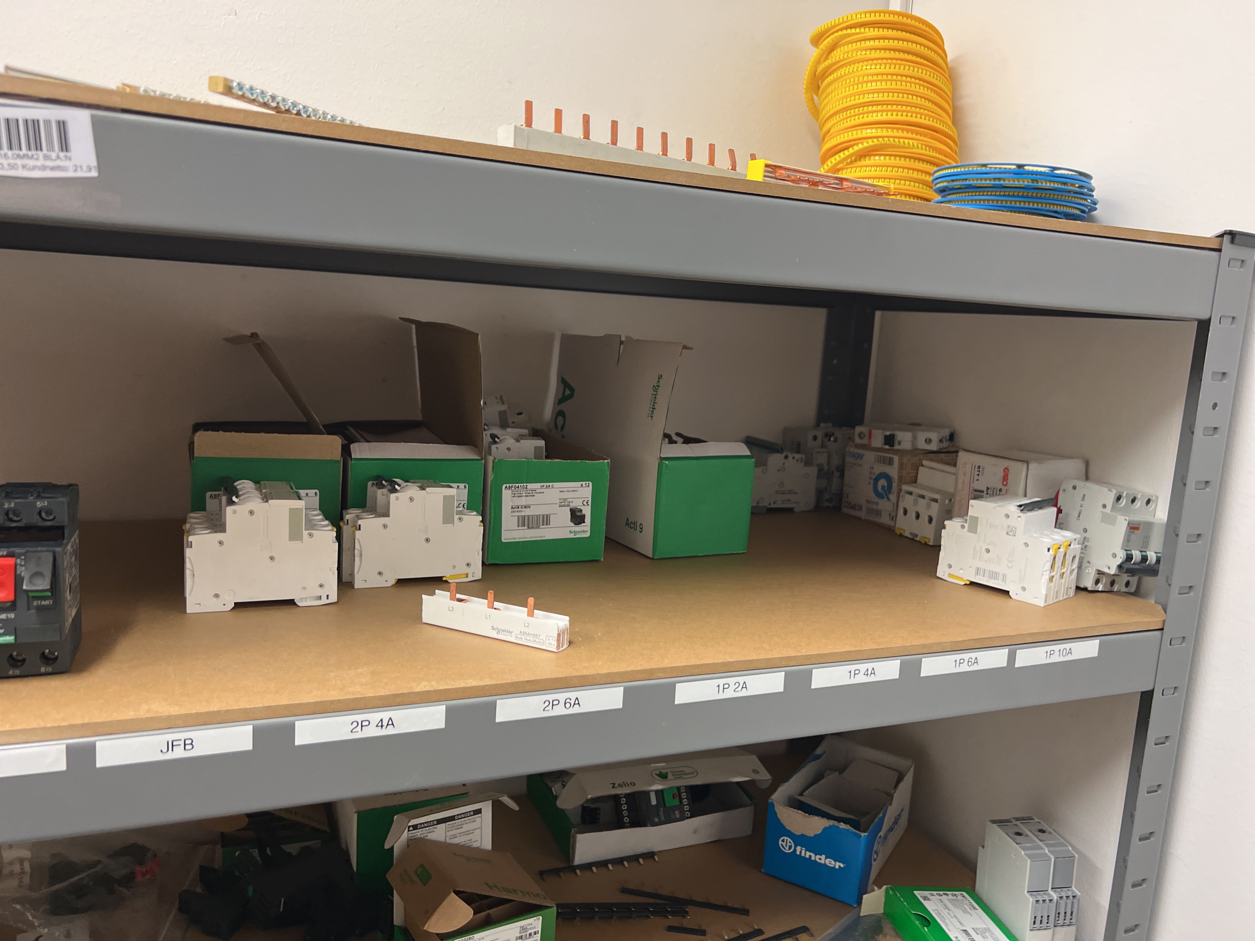 Metal shelves with various electrical installation details and tools ...