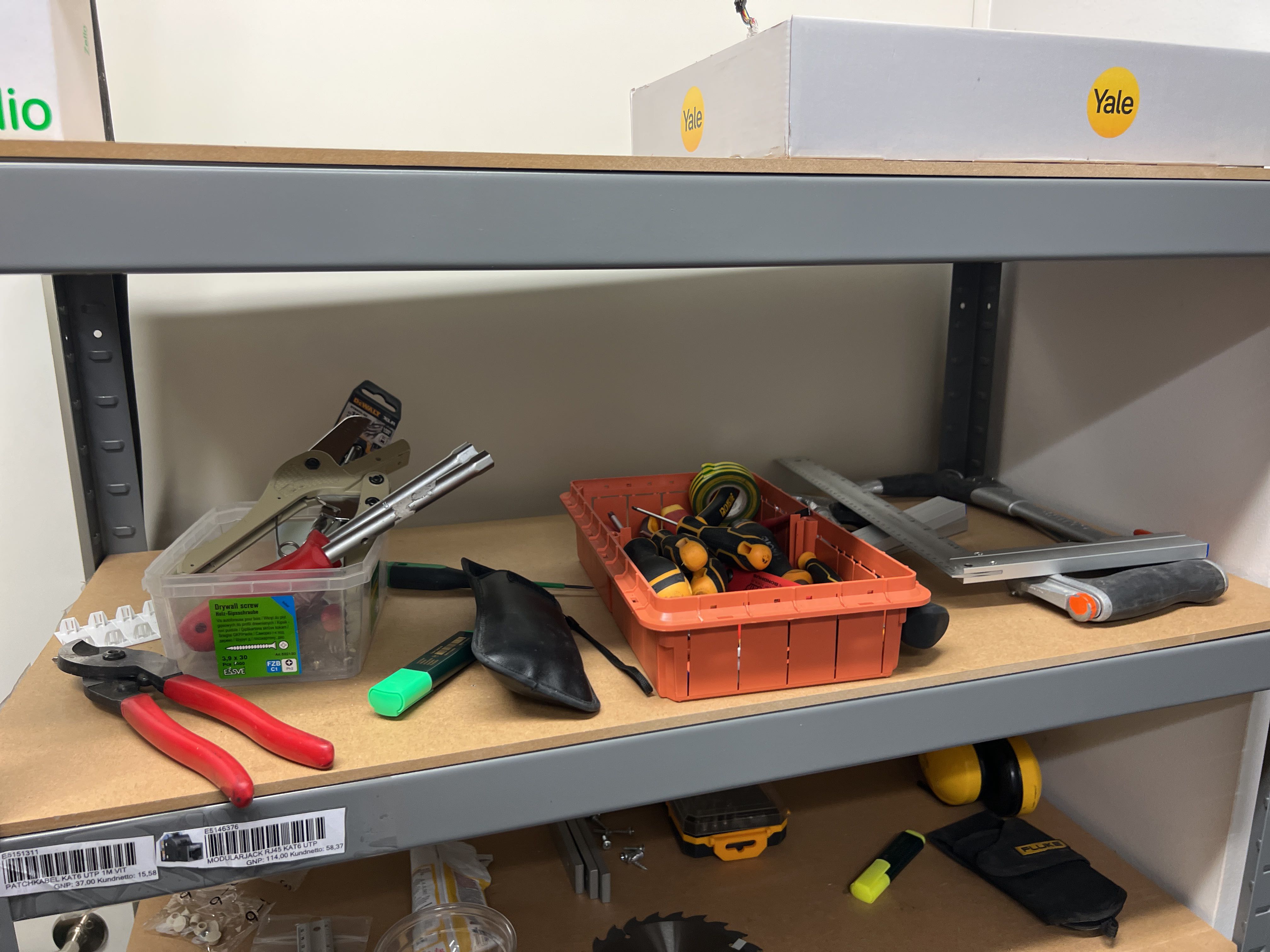 Metal shelves with various electrical installation details and tools ...
