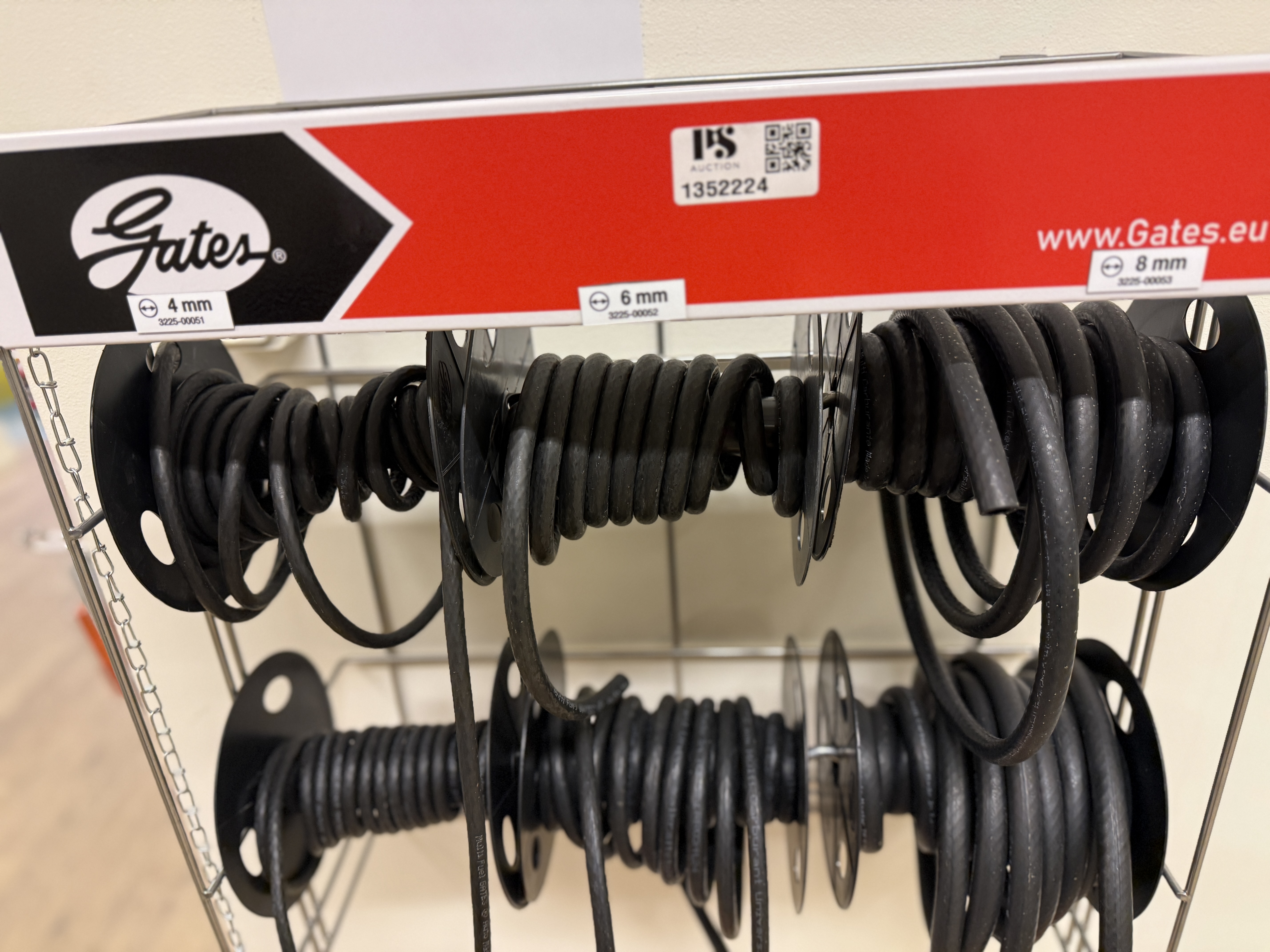 Wall rack with fuel hose assortment. - PS Auction - We value the future ...
