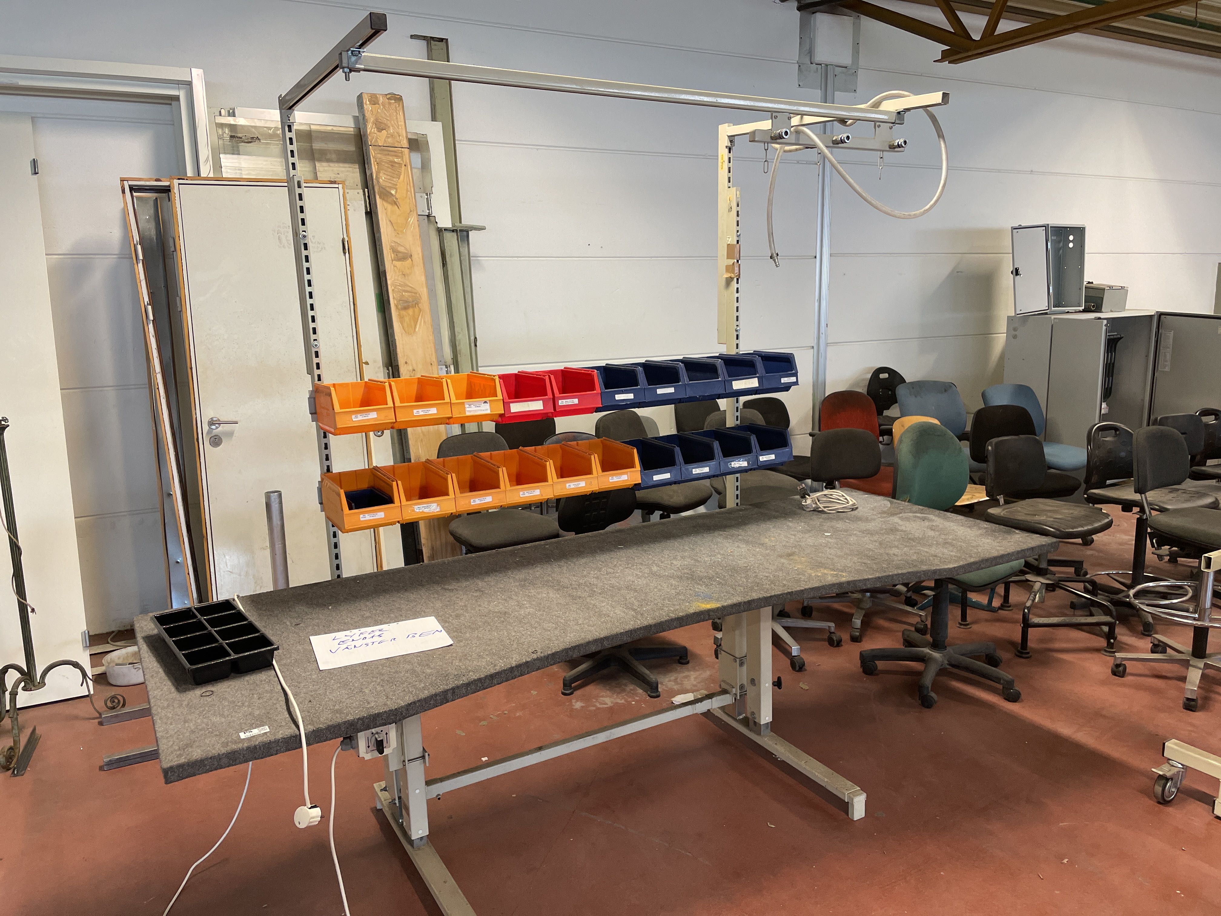 Raised and lowerable desk with assortment boxes on rack - PS Auction ...